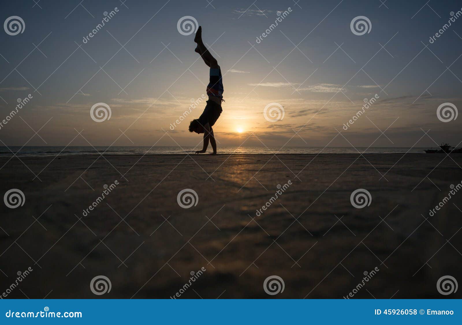 Silhouetted Man Doing Handstand in Sunset Stock Photo - Image of ...