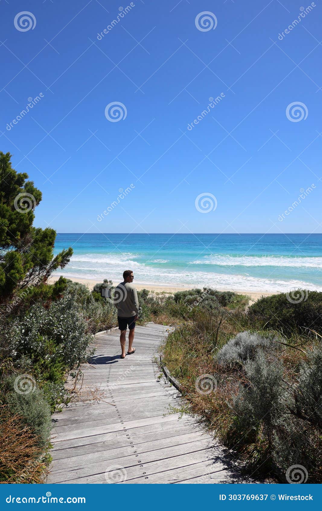 Silhouetted Man Standing on a Path, Looking Out at the Vastness of the ...