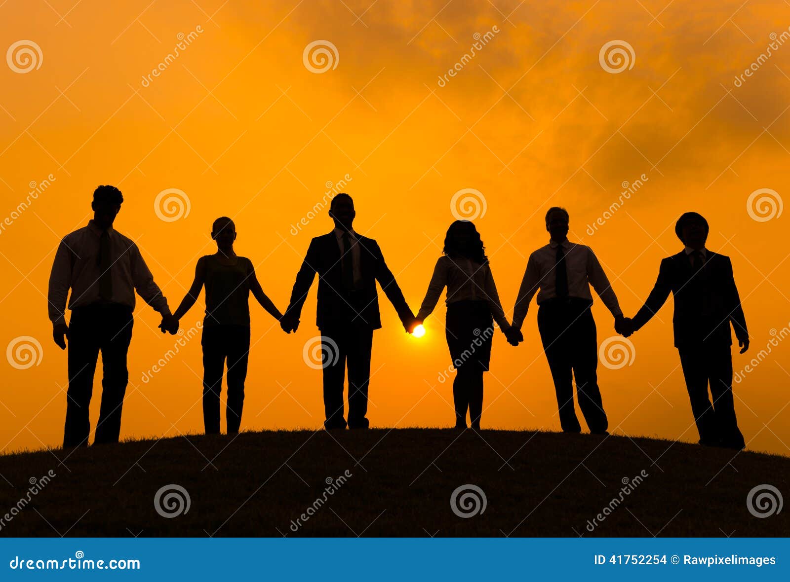 Silhouettes of Business People Holding Hands Outdoors Stock Photo ...