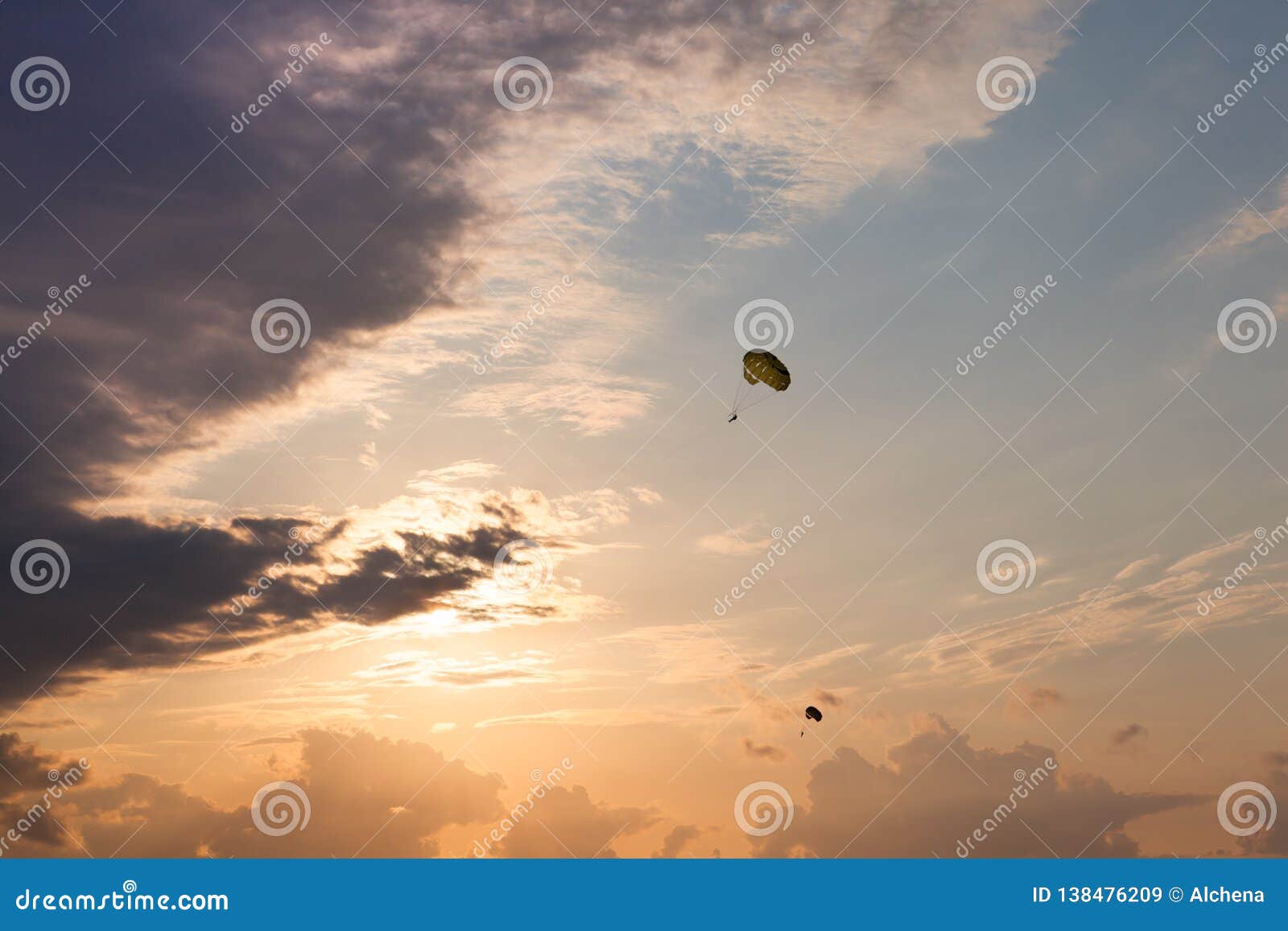 Silhouettes of Flying Parachutes on the Sunset Sky Stock Image - Image ...