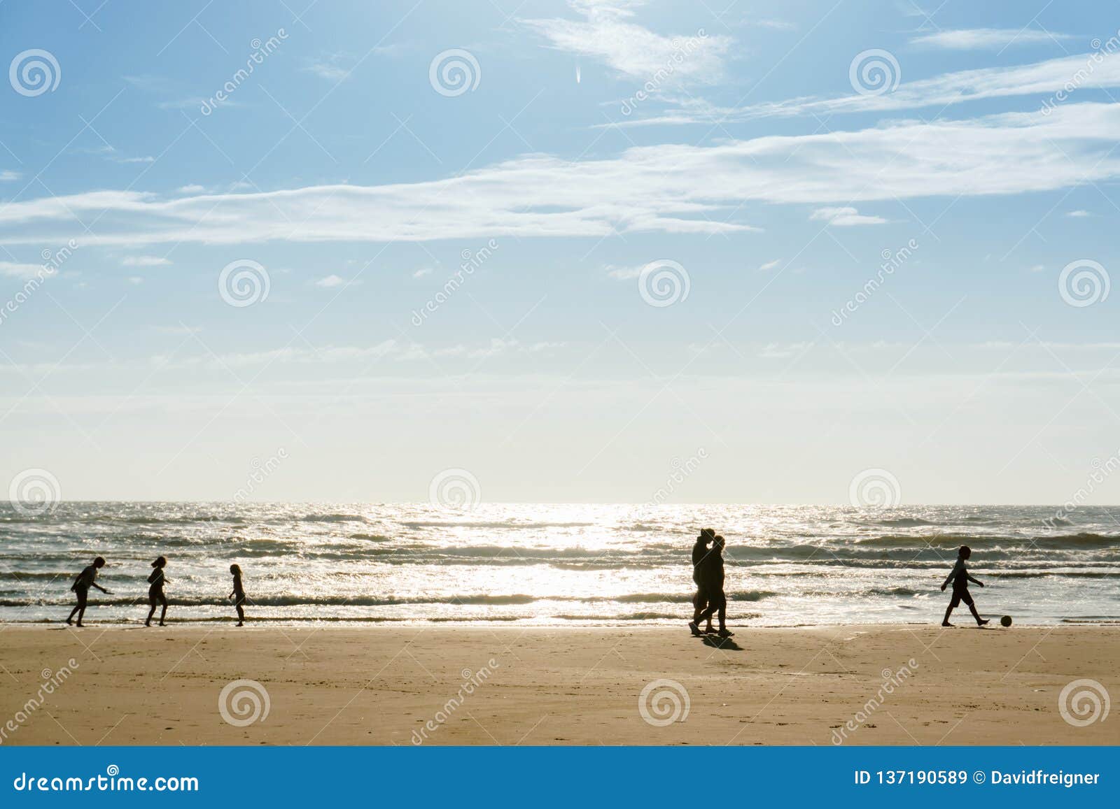 The Silhouettes of a Group of People Walking at the Beach Stock Image ...