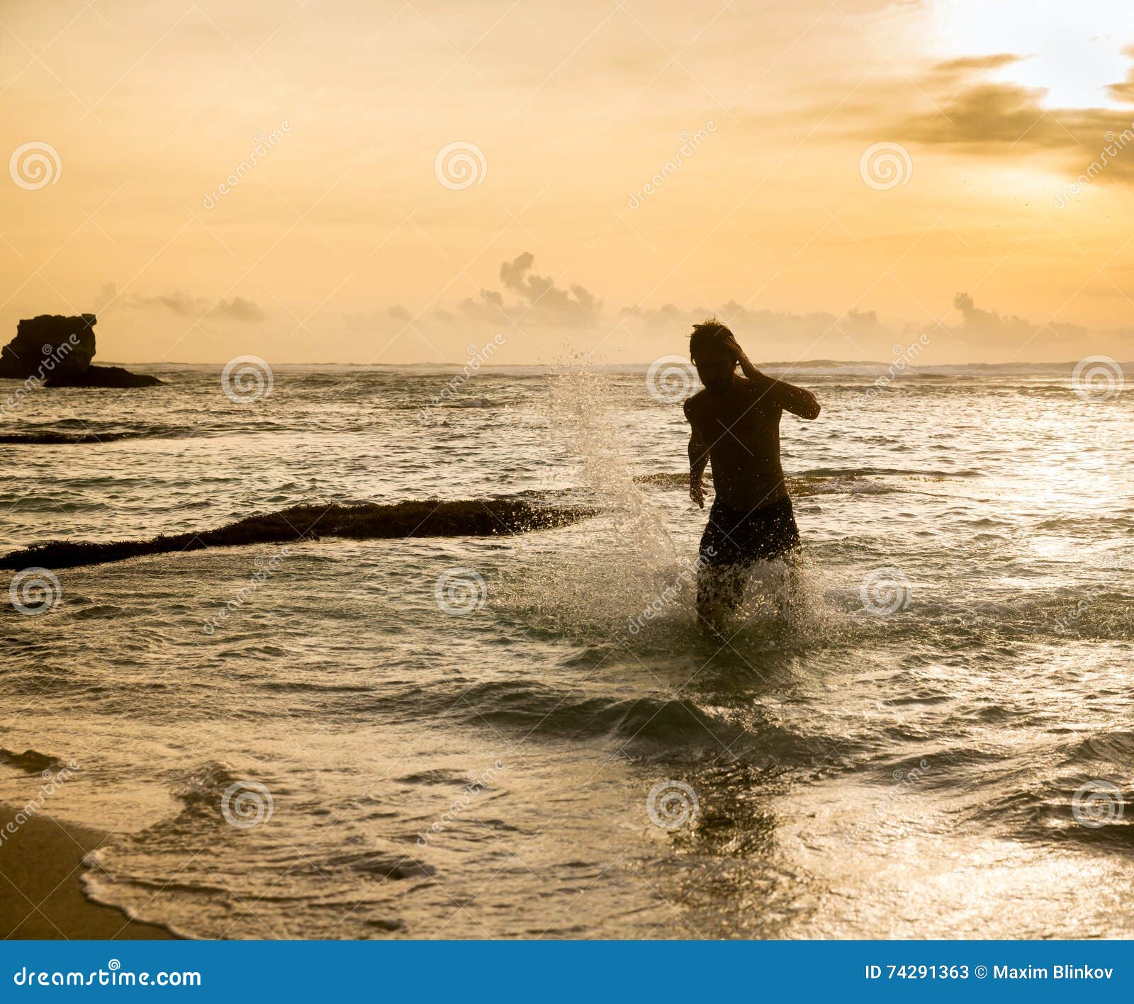 Silhouettes of Man Running Out of Ocean Stock Image - Image of ...