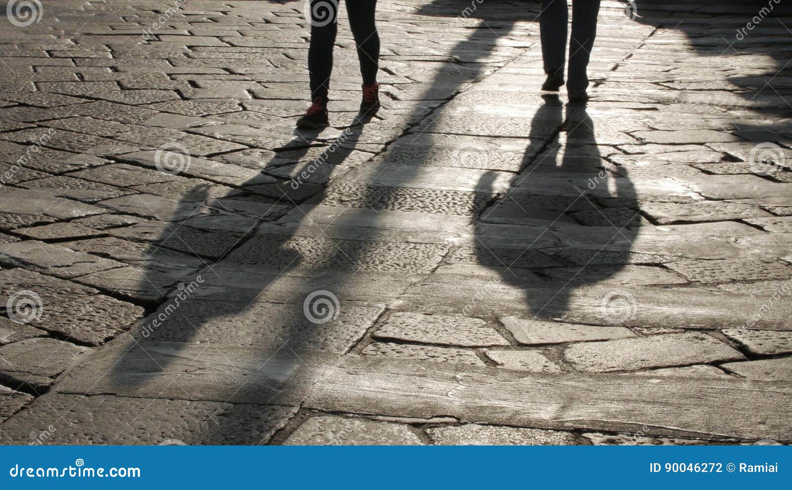 Silhouettes of People on the Cobblestone Pavement. Stock Photo - Image ...