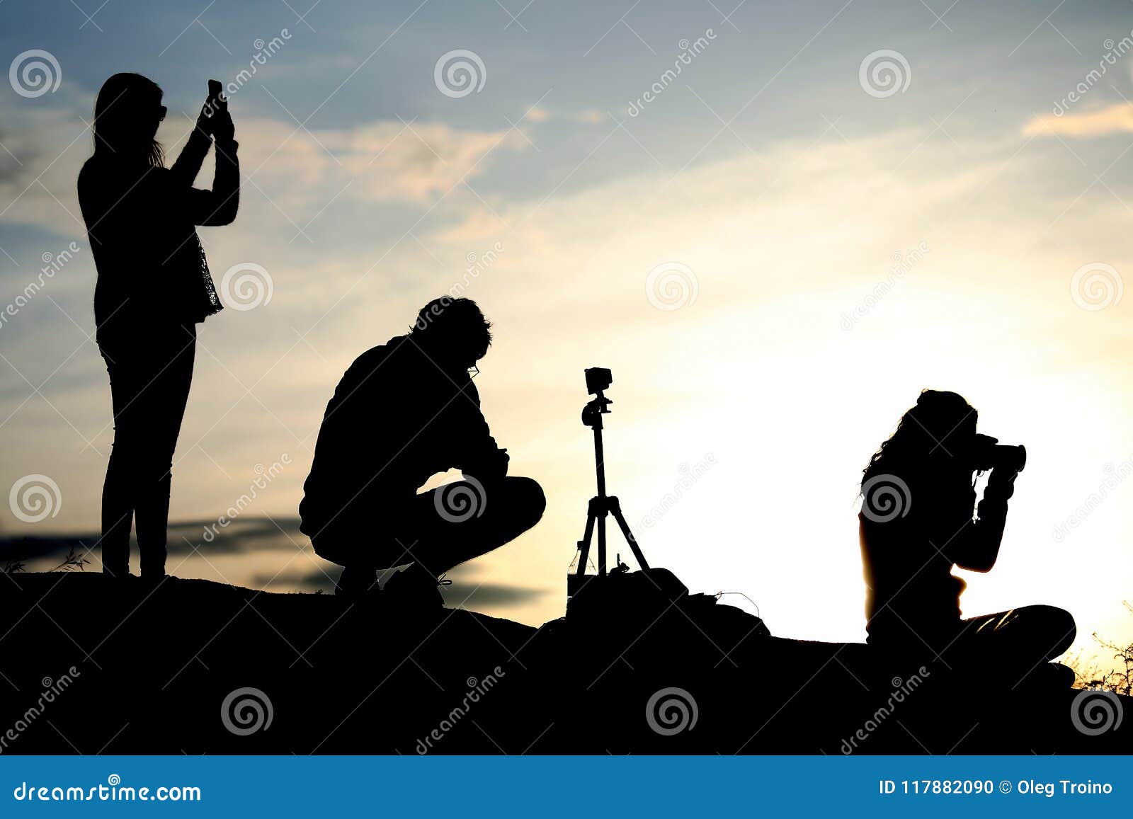 Silhouettes of People Taking Pictures Against the Setting Sun Editorial ...