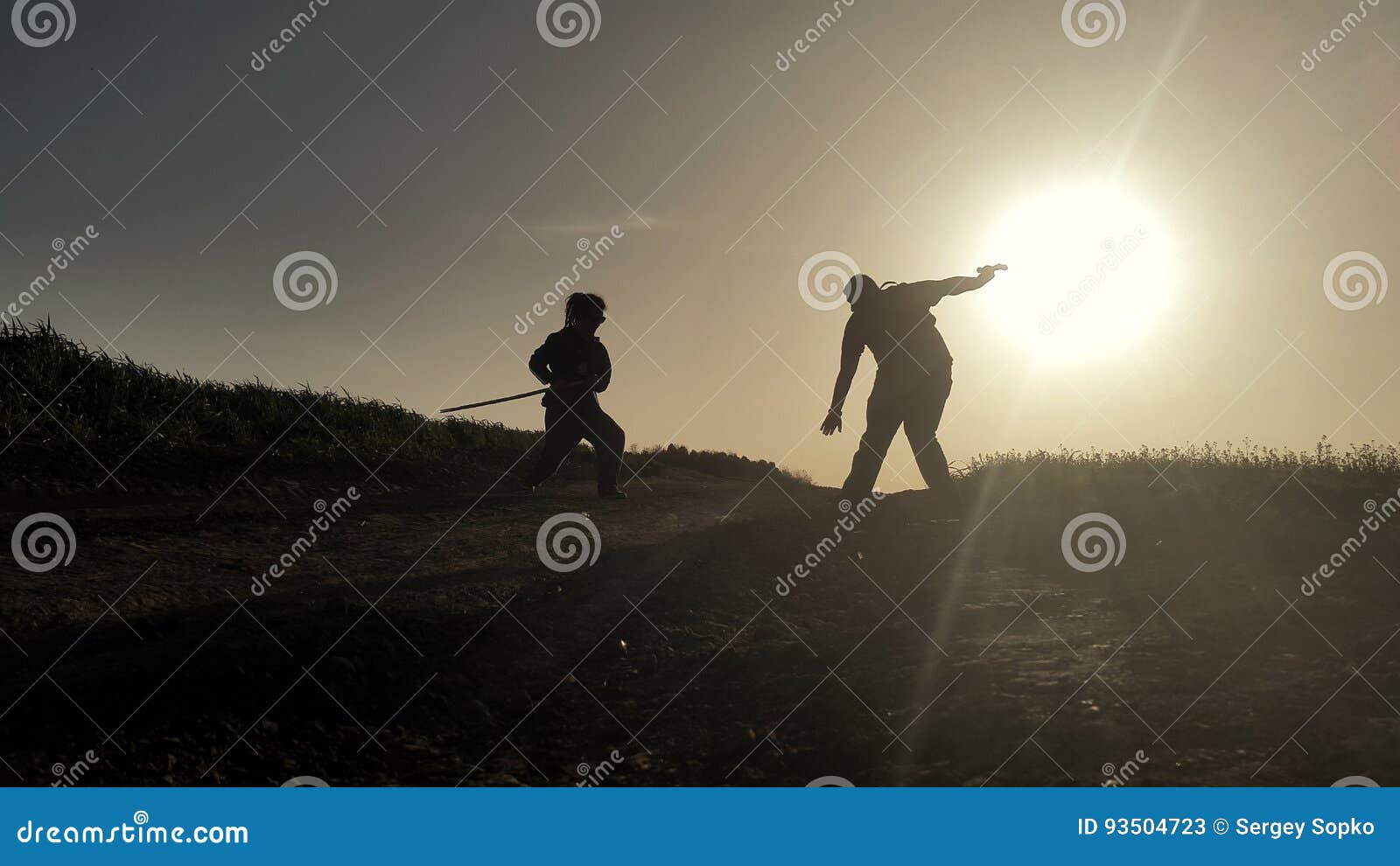 Silhouettes Of Two Samurai Fighting With Swords In The Rays Of Sunset ...