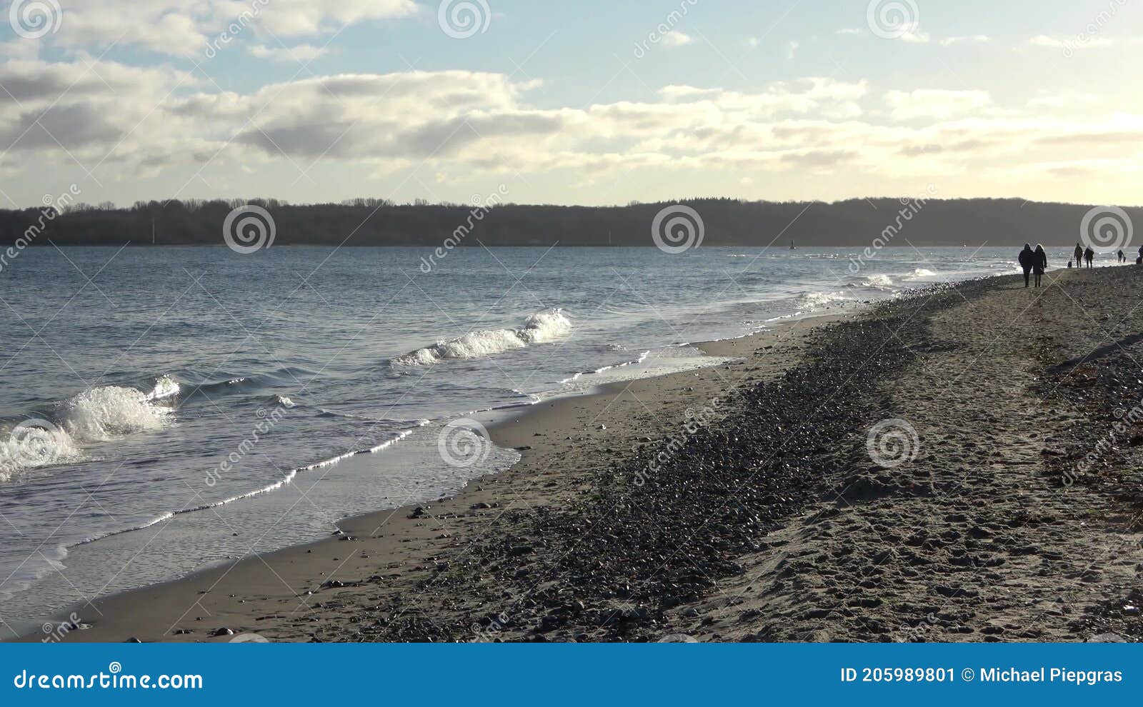 Silhouettes Of Walking People On Sandy Beaches At The Baltic Sea On A