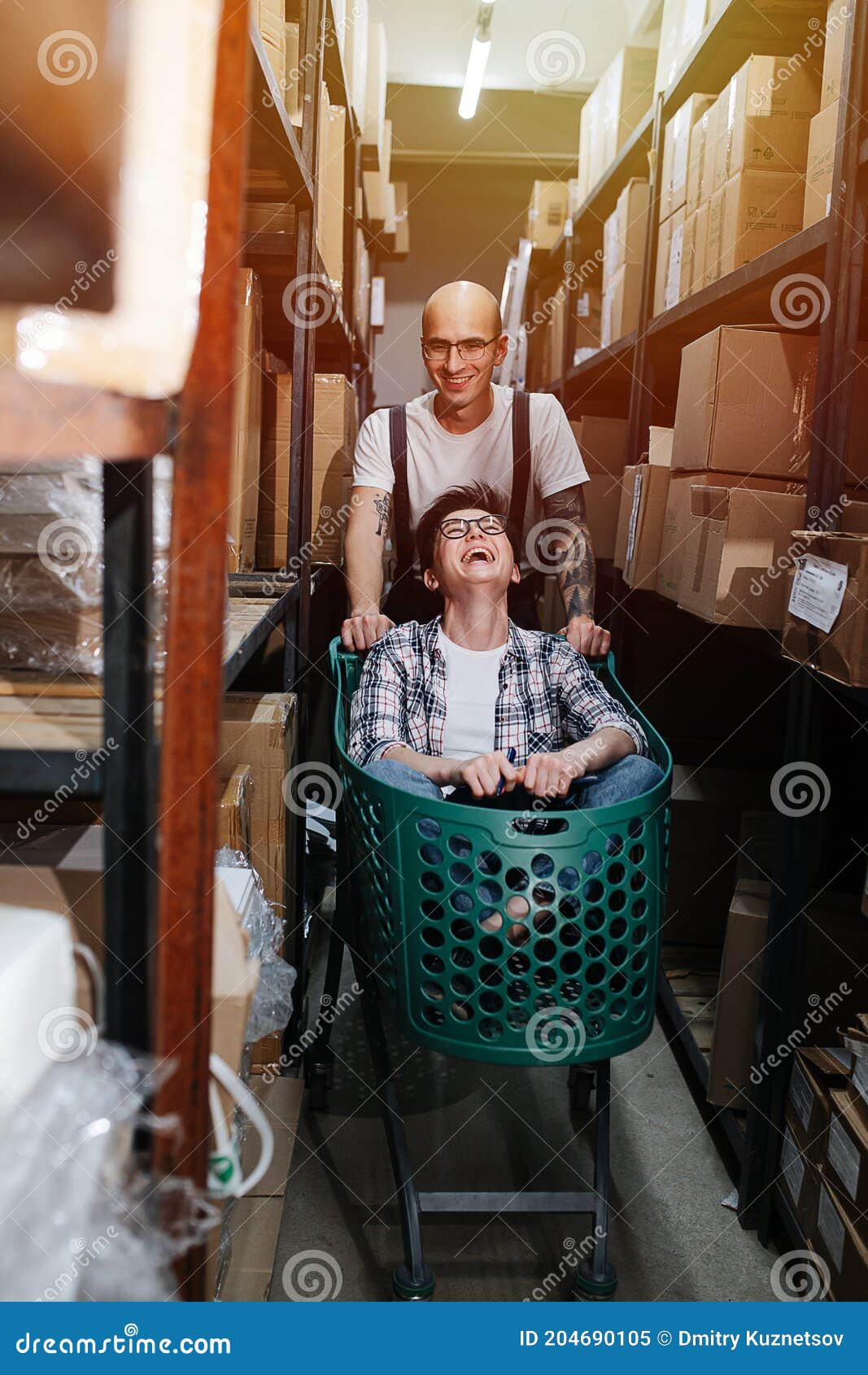 Silly Warehouse Workers Having Fun, Man Pushing Cart with Woman Inside ...