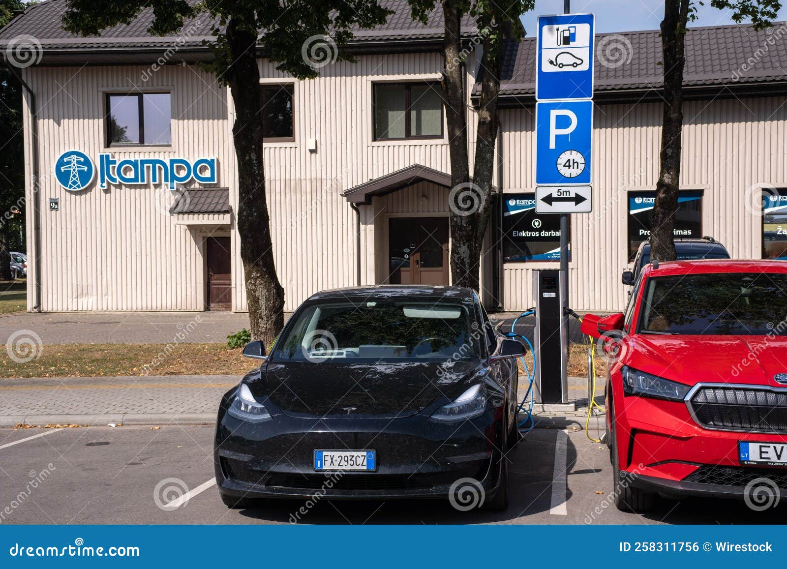 A Static Shot of a Solid Black Tesla Model 3 Dual Motor Charging at the ...