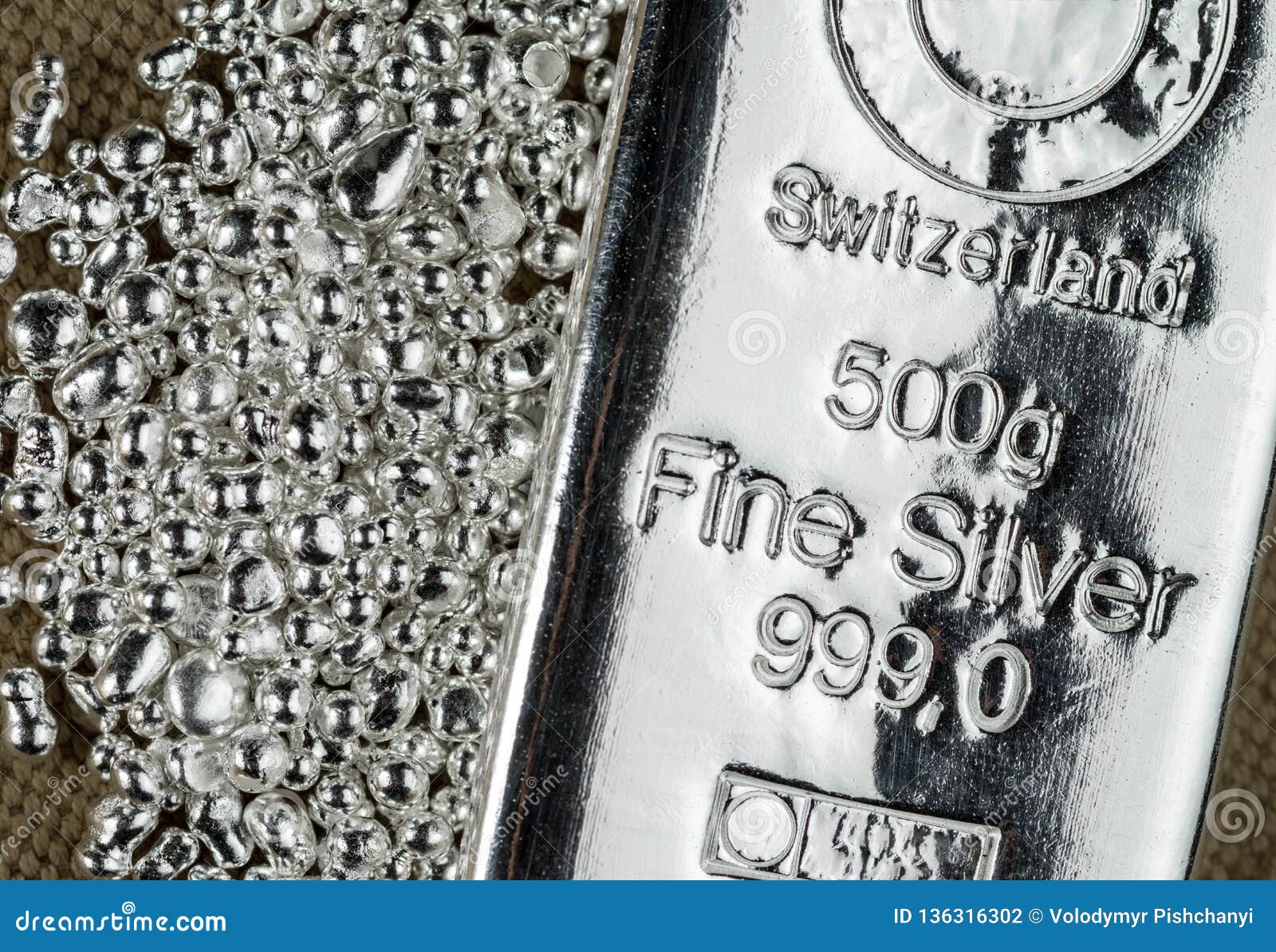 A Silver Bar and a Pile of Silver Grains on the Background To the ...