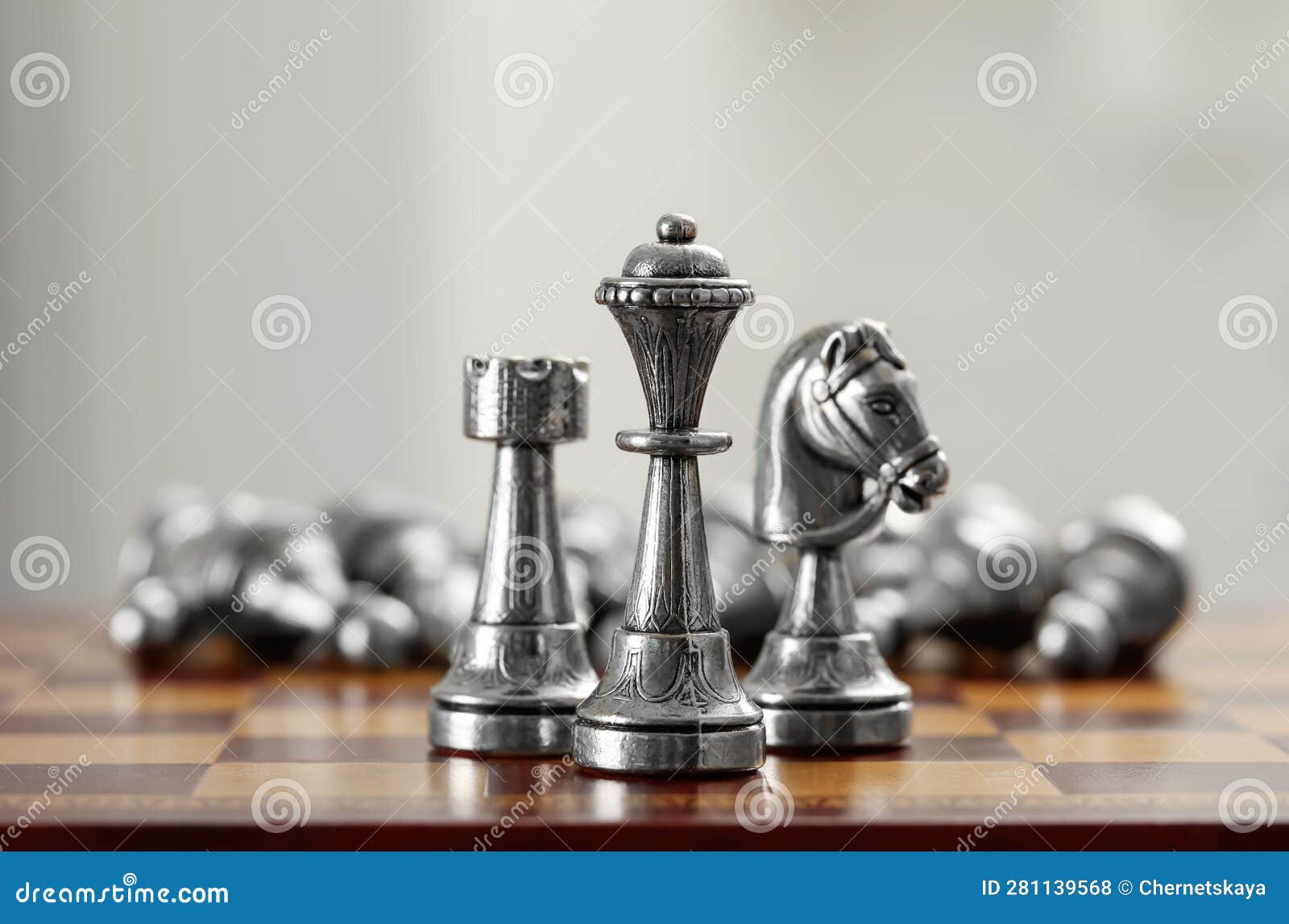 Silver Bishop, Knight and Rook on Wooden Chess Board, Closeup Stock ...