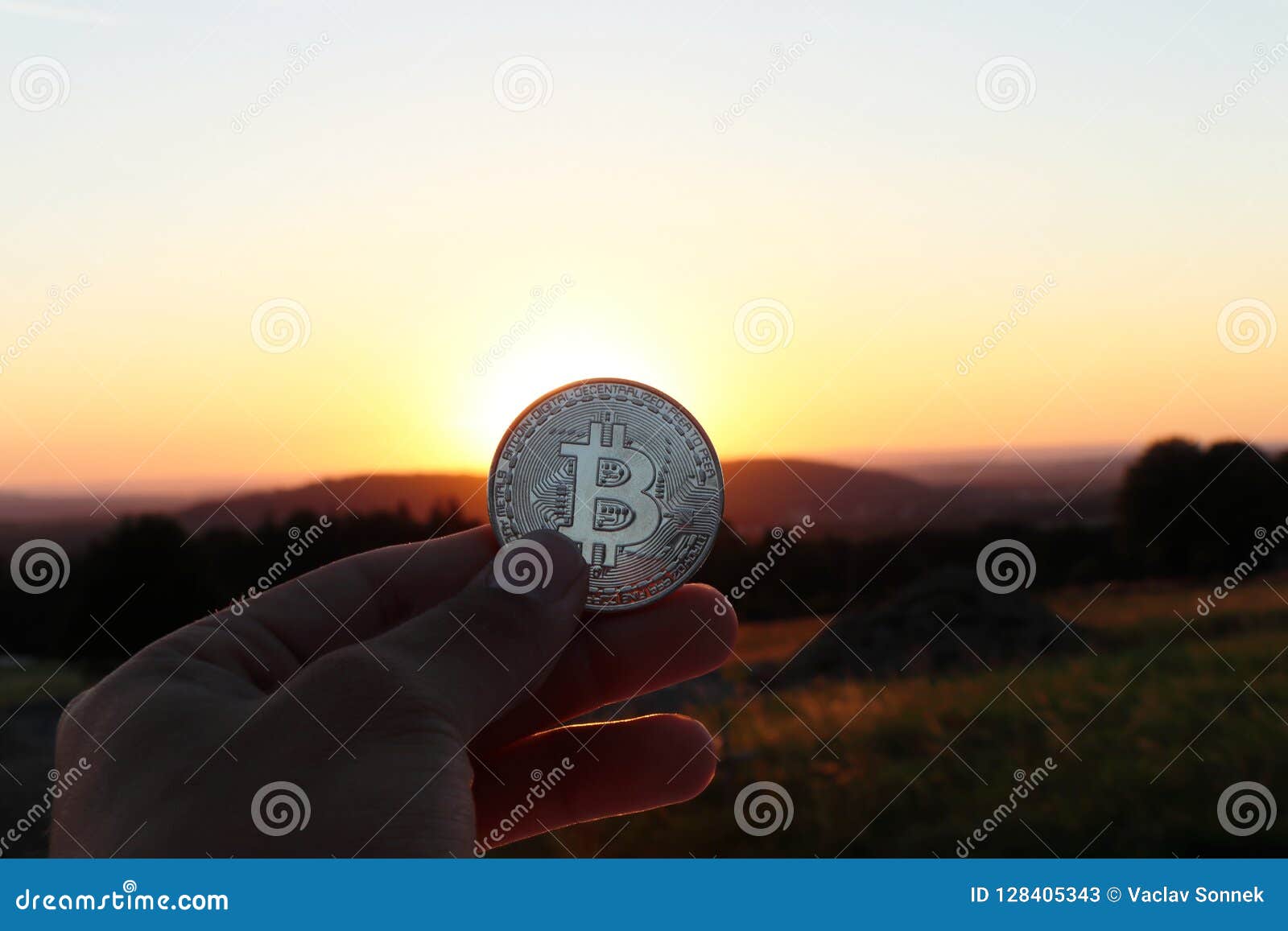 A Silver Bitcoin with Clear Blue Sky and Sunset. Also with Beautiful ...