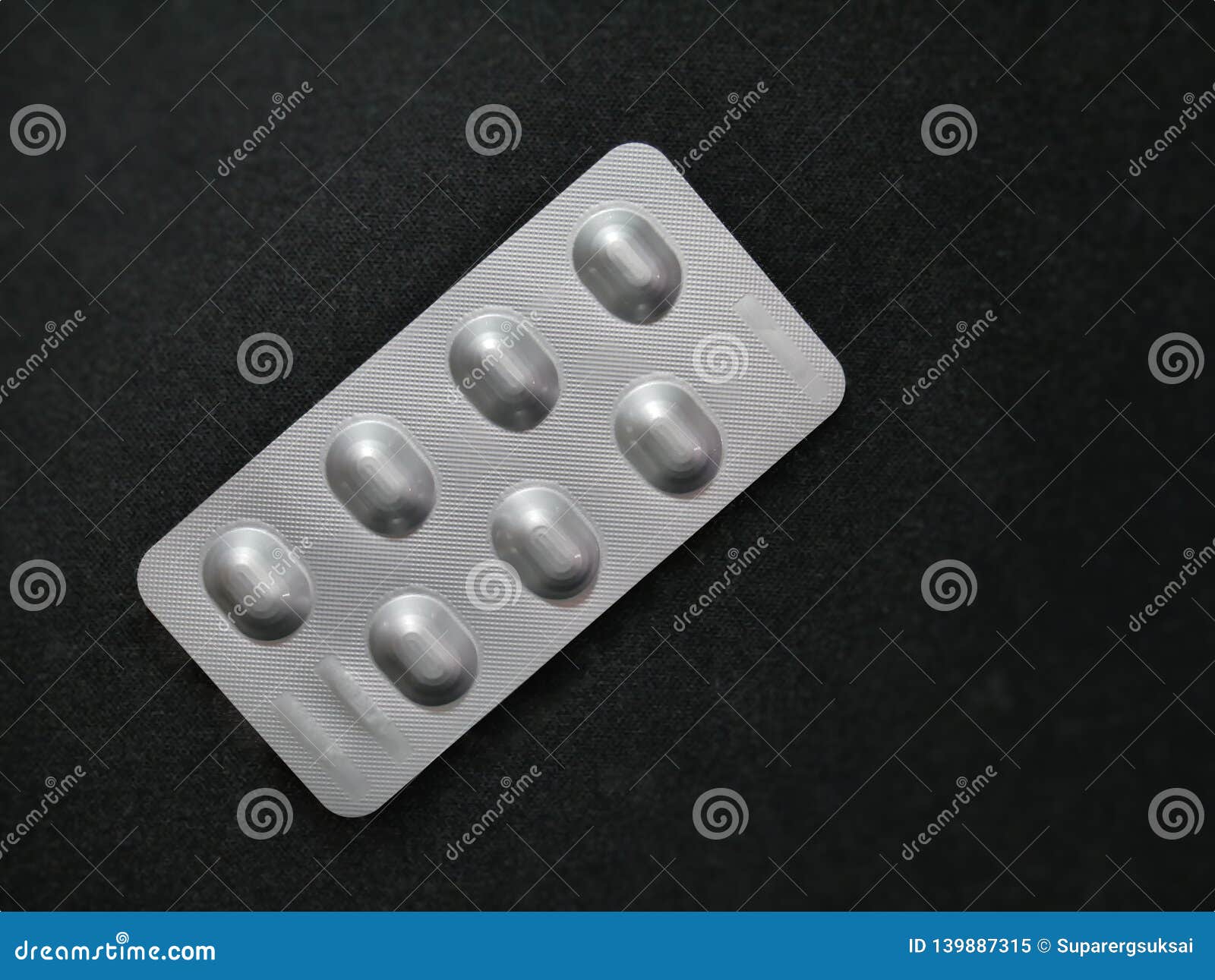 Silver Blister Pack of Medication Pills on Black Background with ...