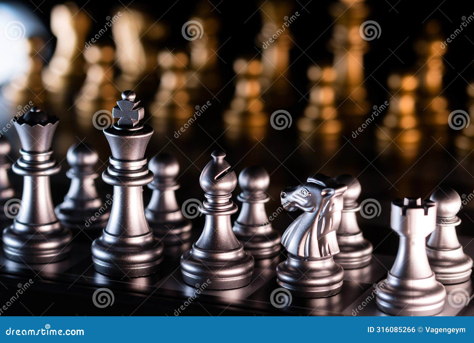 Silver Chess Pieces with Golden Figures in Background Stock Photo ...