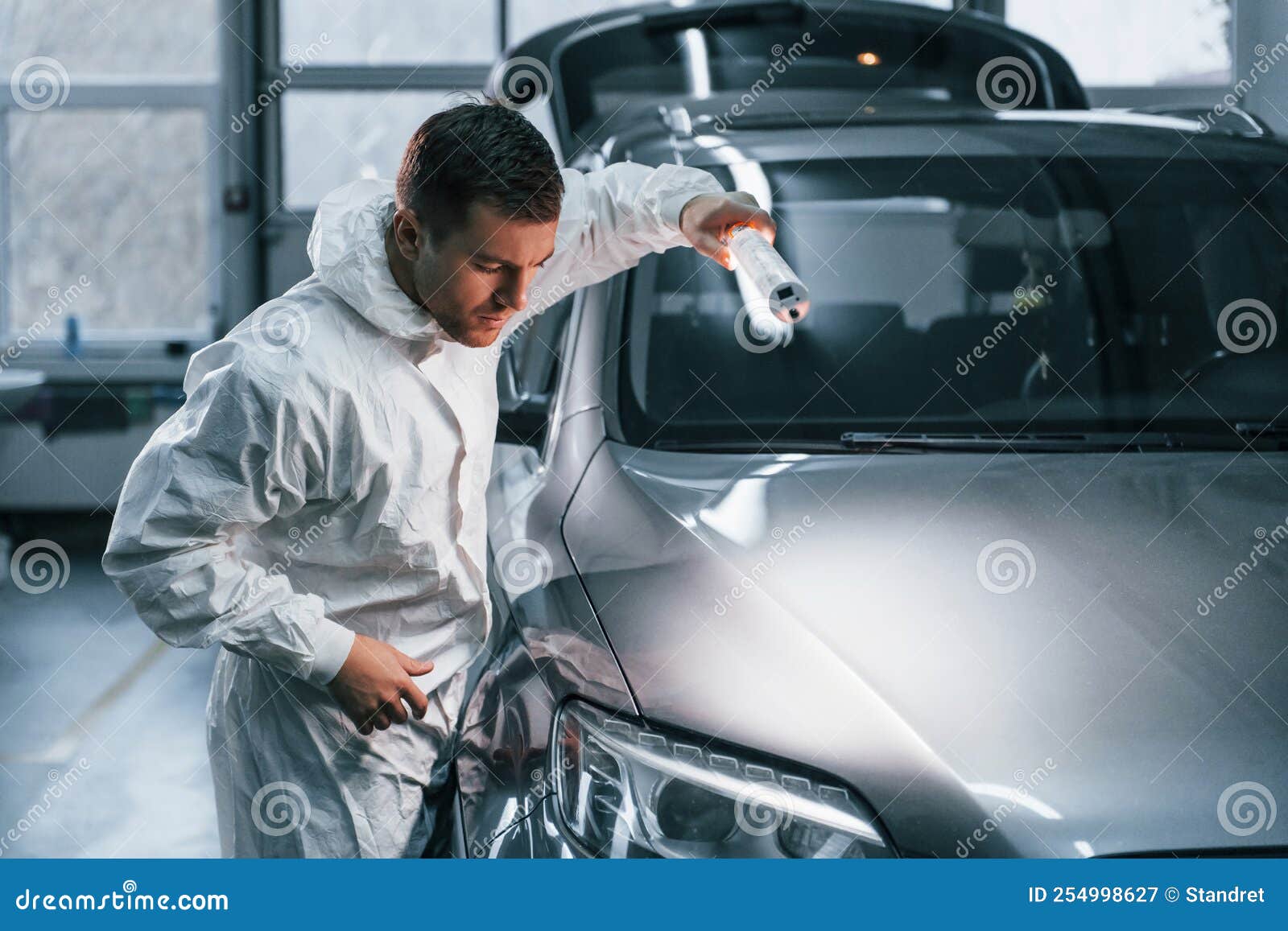 Silver Colored Car. Man in Uniform is Working in the Auto Service Stock ...