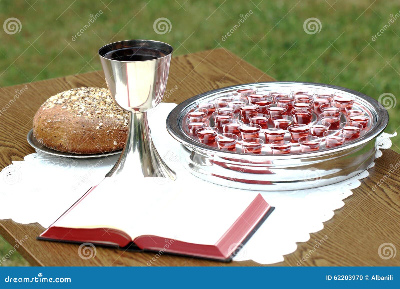 Silver Communion Ware with Open Bible and Bread Stock Photo - Image of ...