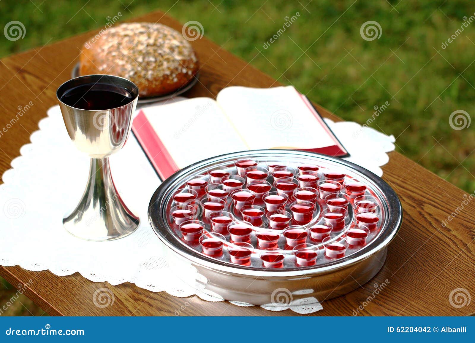 Silver Communion Ware with Open Bible and Bread Stock Photo - Image of ...