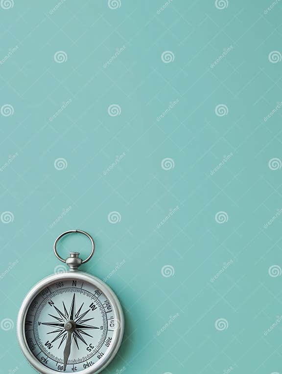 A Silver Compass Sits on a Mint Green Background. the Compass Features ...