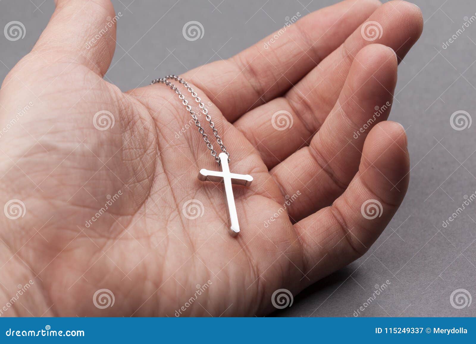 Silver cross in a hand stock image. Image of sign, holy - 115249337