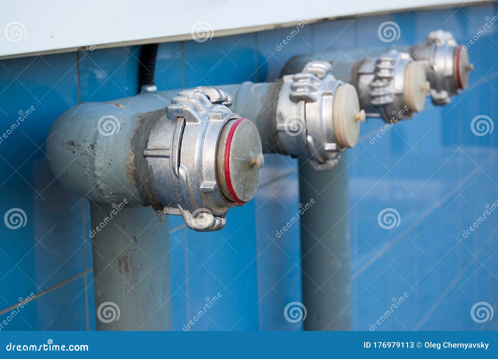 Silver Fire Hydrants on the Blue Wall of the Building Stock Image ...