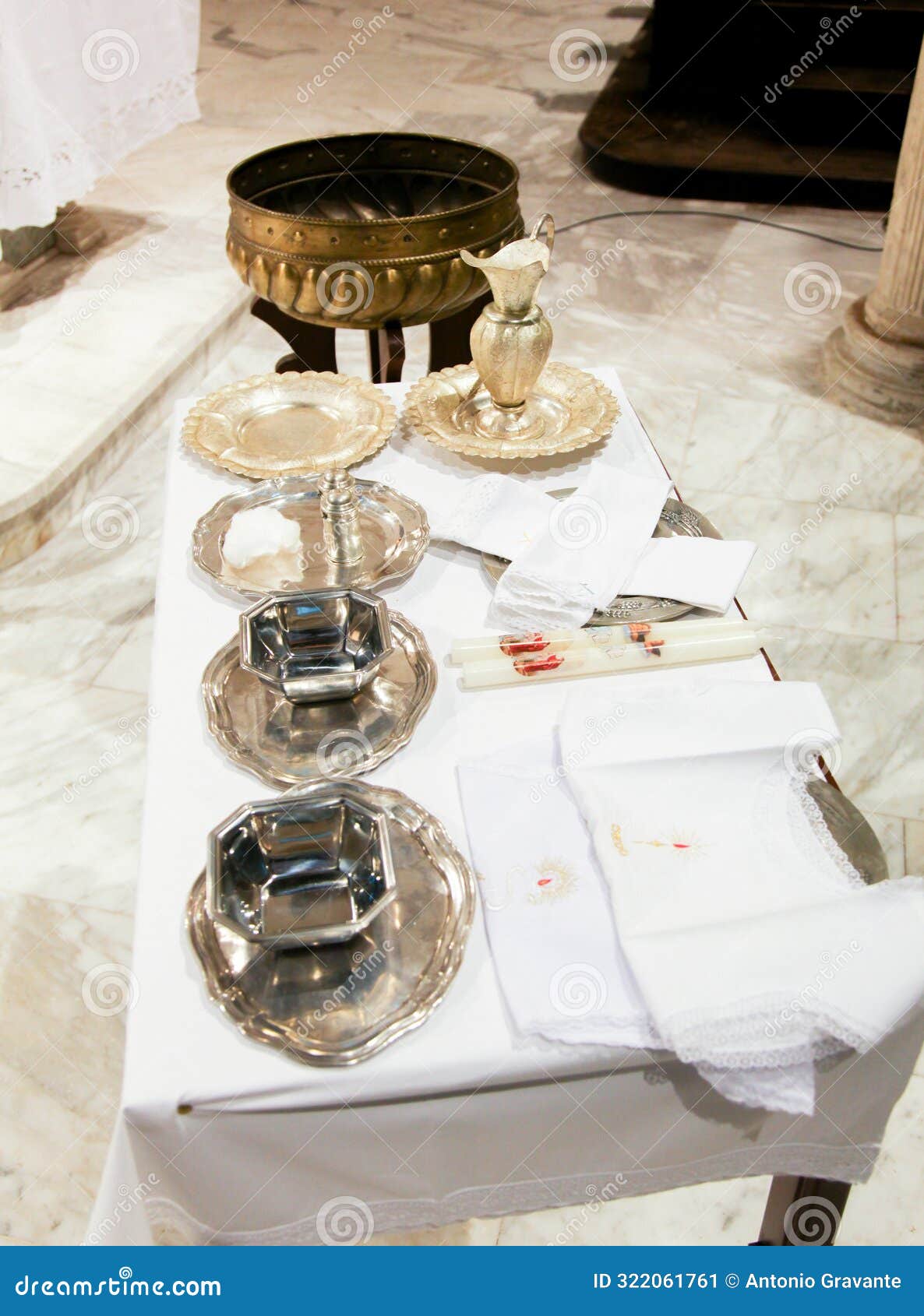 Religious Silver and Gold Items Displayed on a Table with a White ...