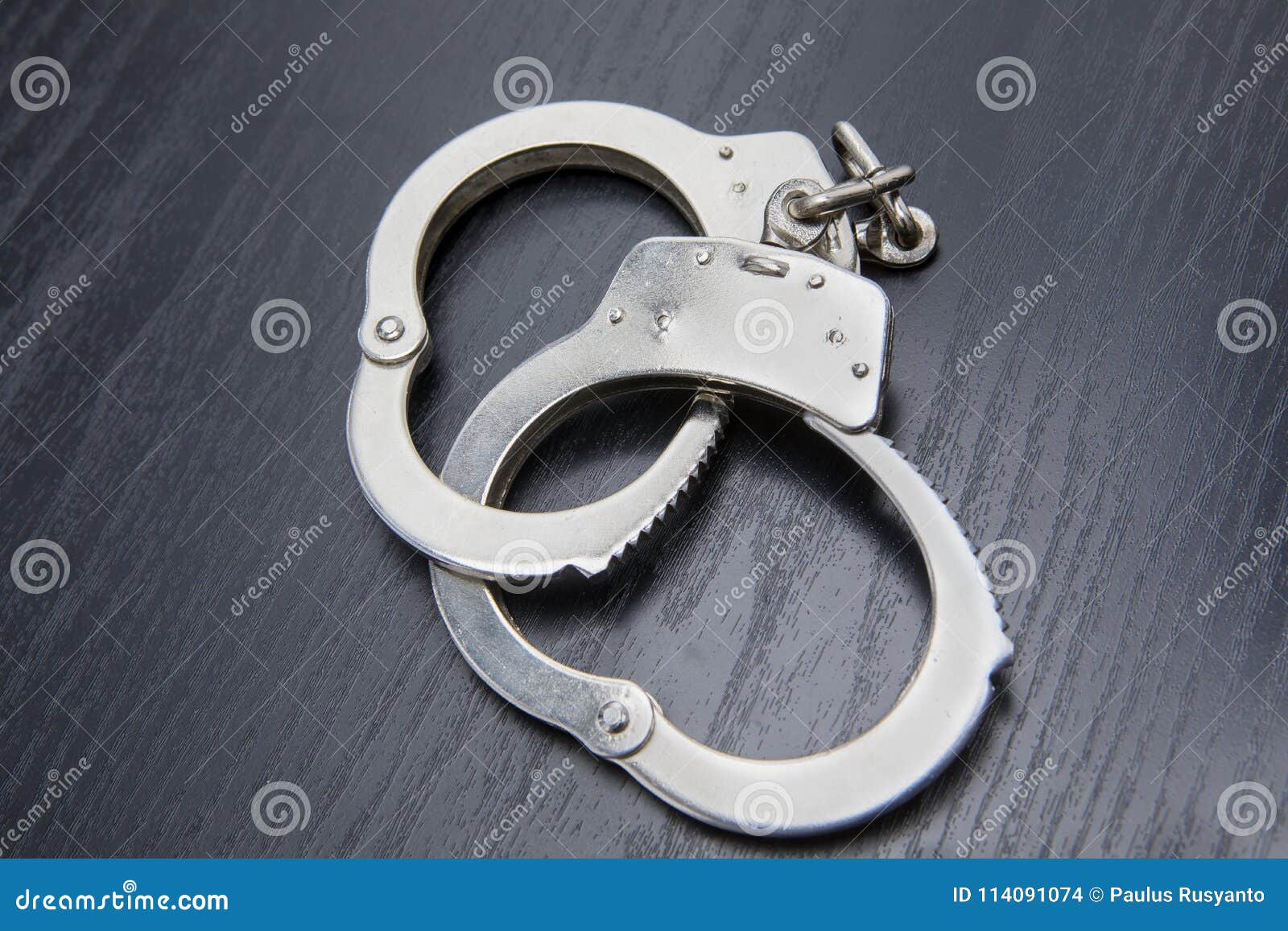 Silver Handcuffs Above Wooden Table Stock Photo - Image of black ...