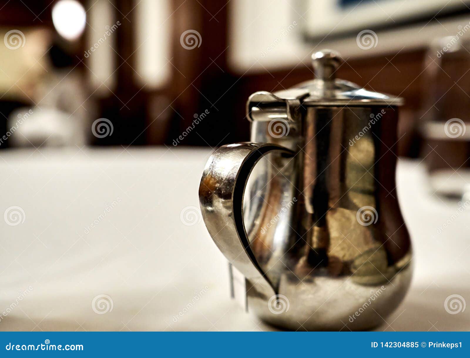 Silver Jug Reflecting the Surrounding Environment at a Restaurant Stock ...