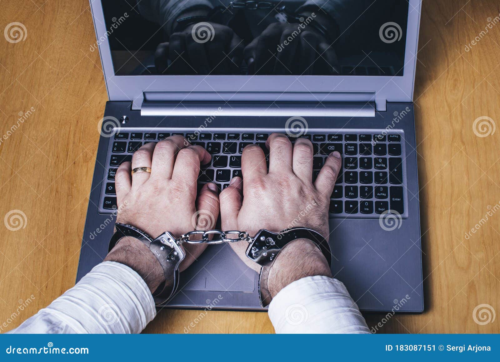 Silver Laptop on the Table with Silver Handcuffs. Stock Image - Image ...