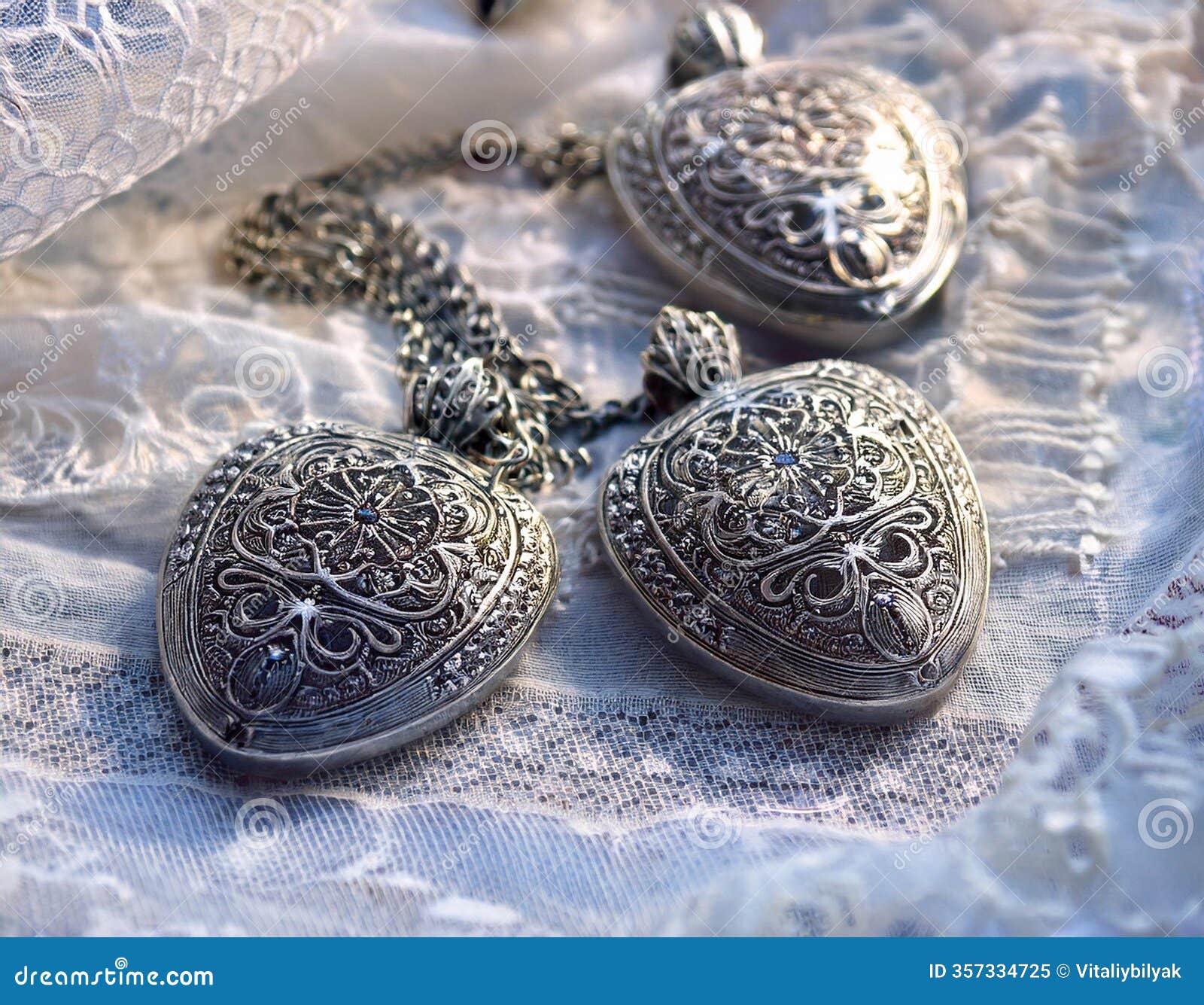 Silver Lockets With Intricate Floral Engravings Lying On A Bed Of Lace ...