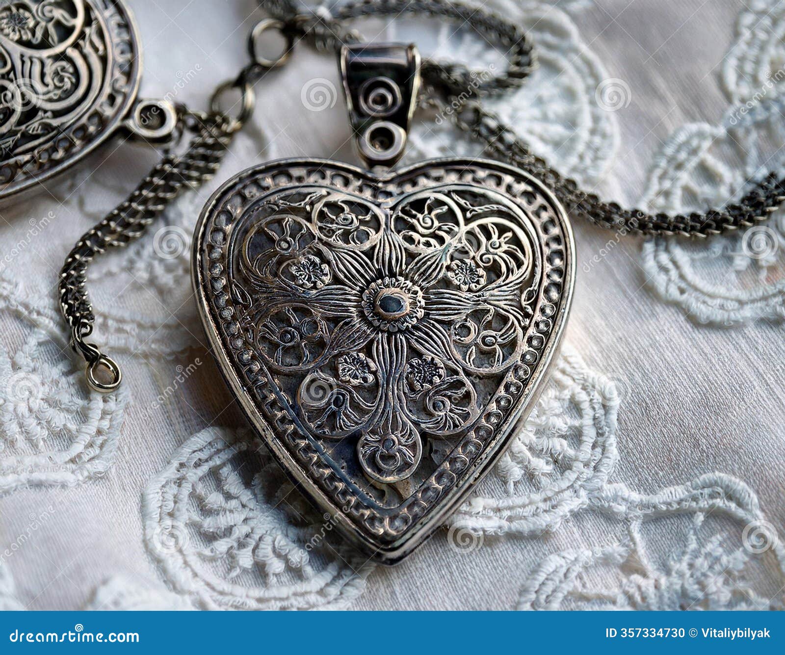 Silver Lockets With Intricate Floral Engravings Lying On A Bed Of Lace ...