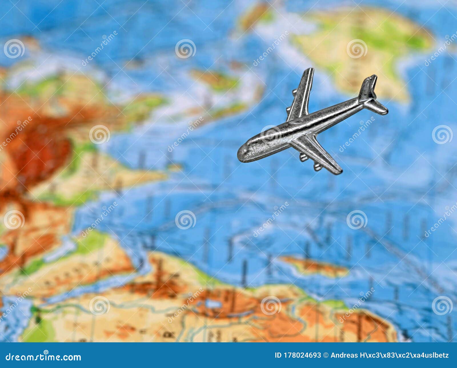 Silver Miniature Airplane Above Blurred Map on Background Stock Image ...