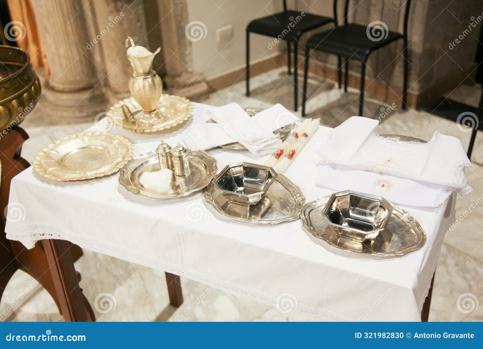 Silver Plates and Religious Items are Lying on a Table with a White ...