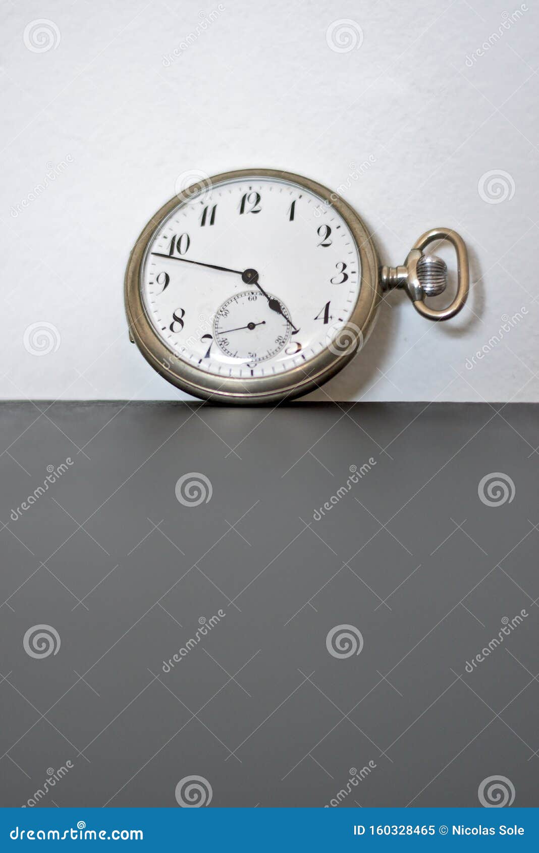 Silver Pocket-watch on a Black Surface Resting on the Wall Stock Image ...