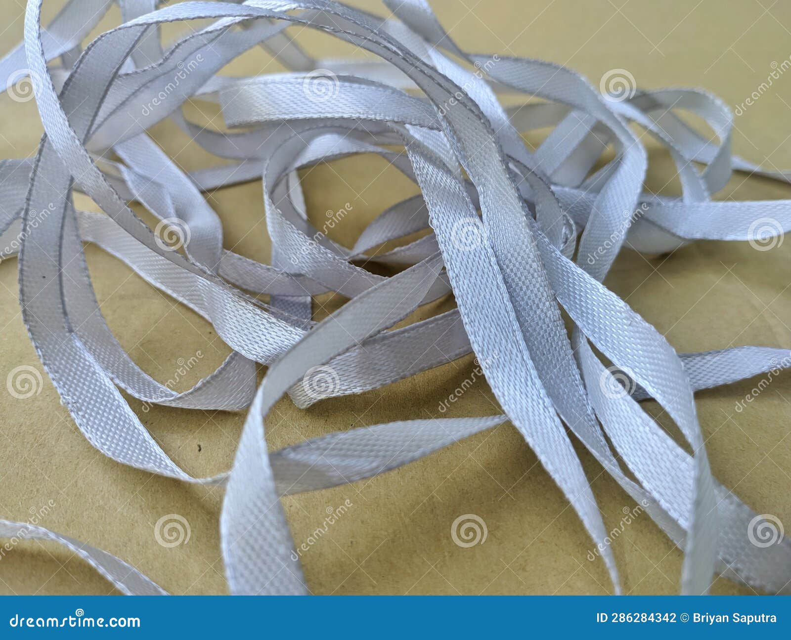 Silver Ribbon Rolls on Light Brown Wallpaper Stock Photo - Image of ...
