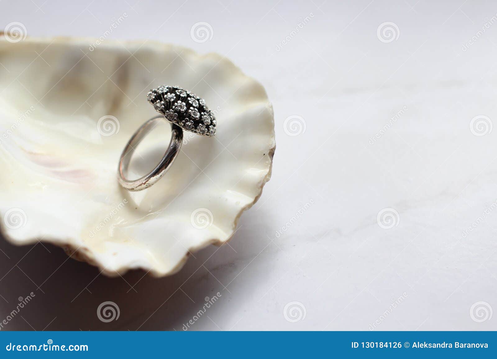 Silver Ring with Precious Stones on a Shell, Marble Background Stock ...