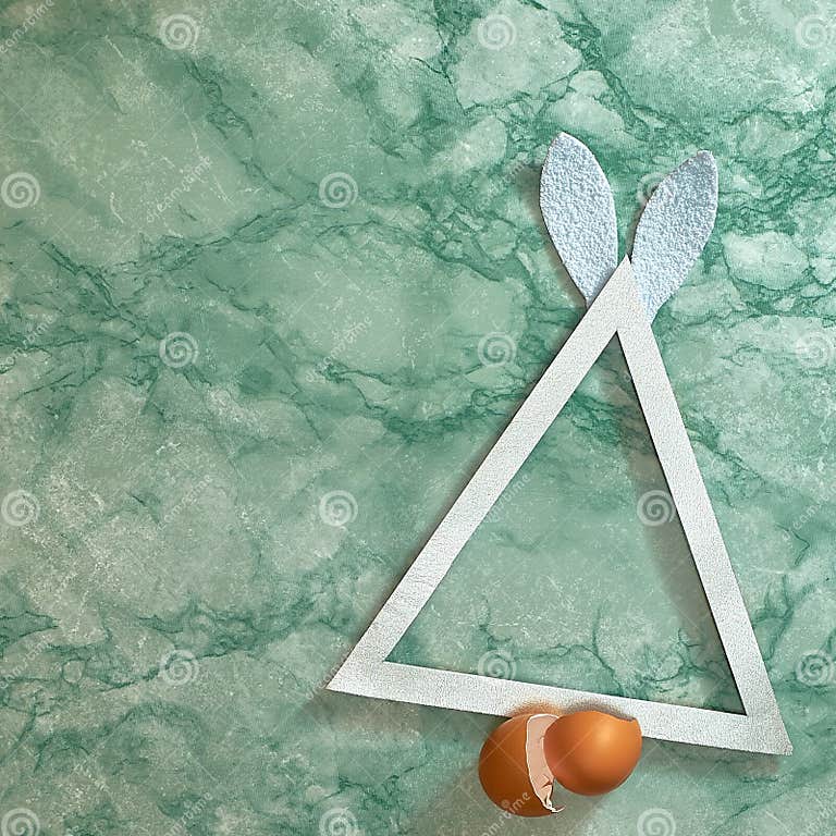 Silver Triangle. Rabbit White Ears and Egg Shells on a Green Marble ...