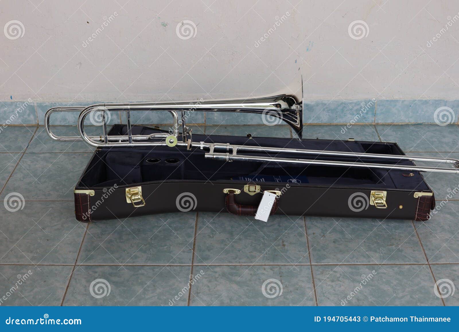 The Silver Trombone Instrument is Placed in a Black Box on the Floor ...