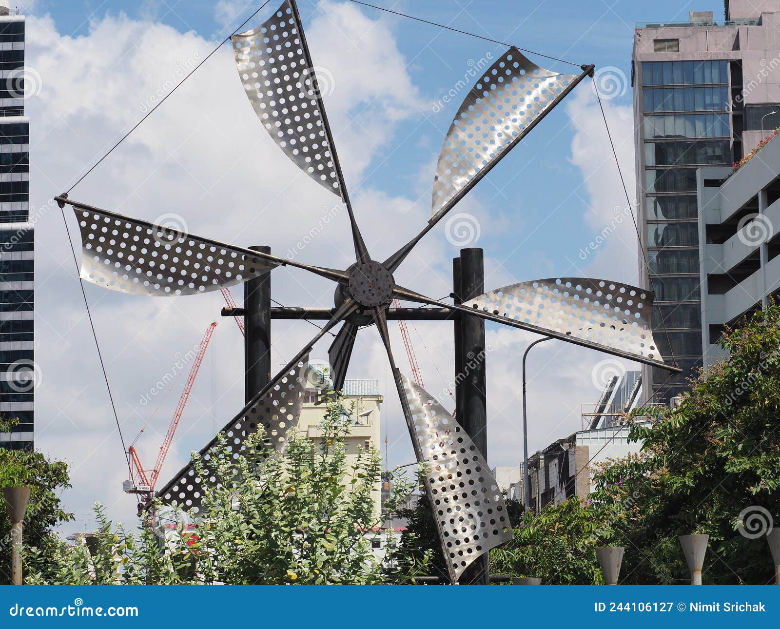 Silver Windmill with Sky and Buildings Stock Image - Image of tree ...
