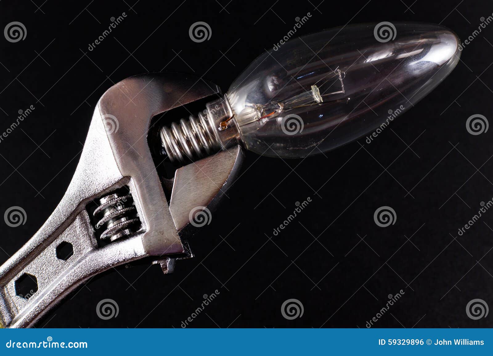 Silver Wrench Clenching a Fragile Lightbulb Stock Photo - Image of idea ...
