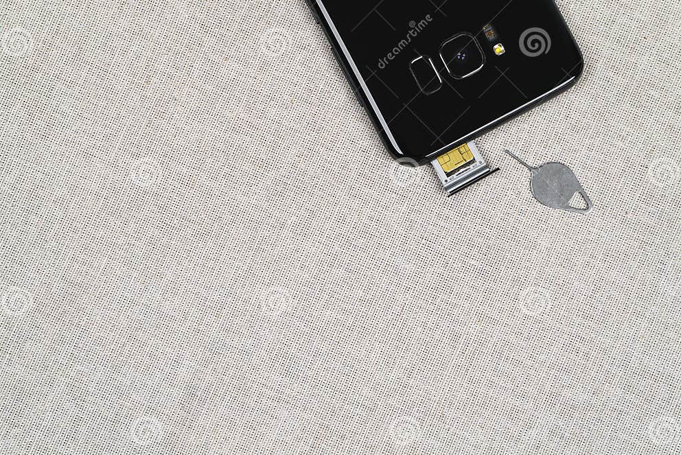 Sim Ejector Tool and SIM Card Slot of Mobile Phone. Top View Stock ...