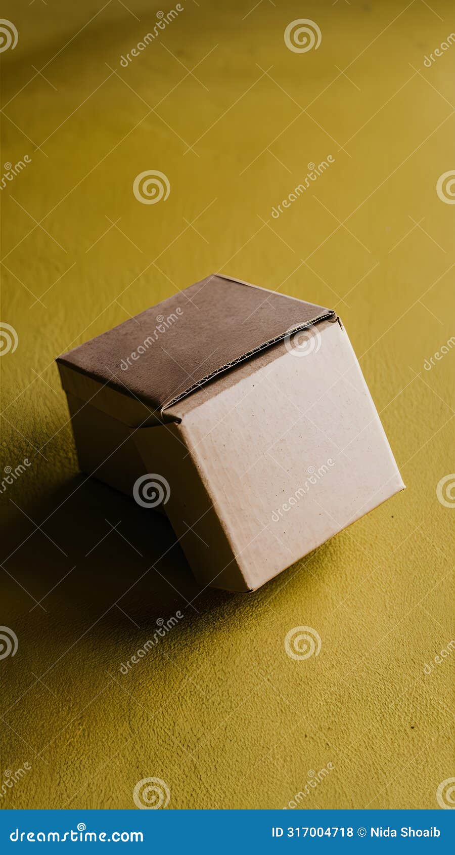 Simple, Functional Tilted Cardboard Box on a Yellow Surface, Closed Lid ...