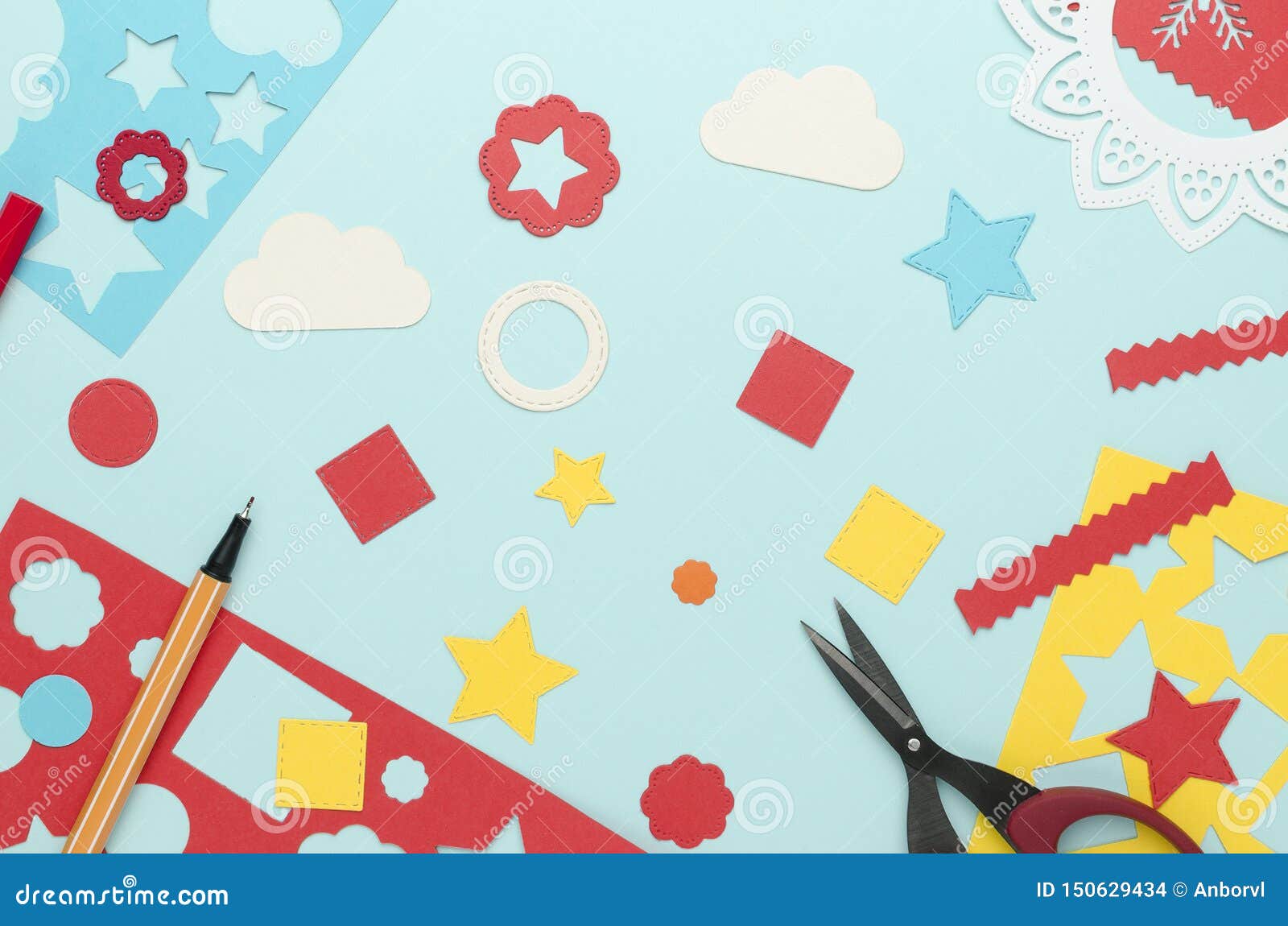 Simple Geometric Shapes Cut from Colored Paper Scattered on a Blue ...