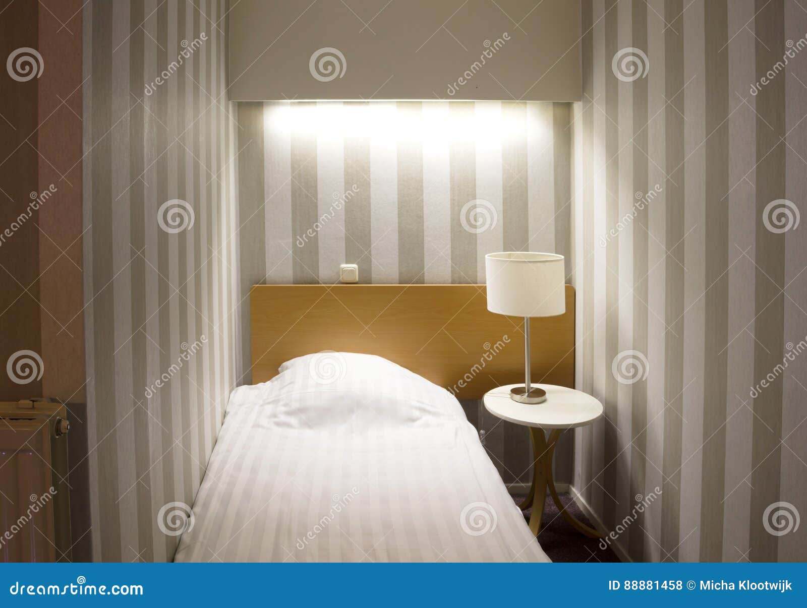 Simple Hotel Room, Single Bed Stock Photo - Image of light, wallpaper ...