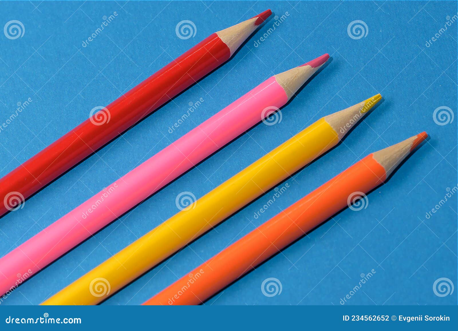 A Simple Image. Four Colored Pencils on a Blue Background Stock Photo ...