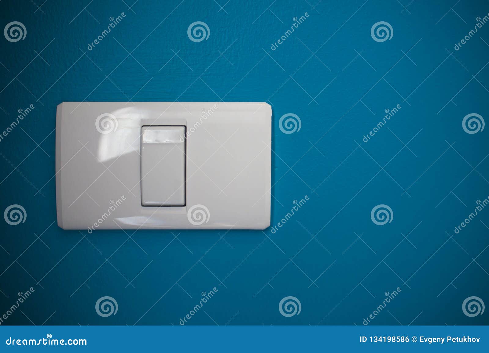 Simple Light Switch, White on a Blue Wall with Stock Photo - Image of ...
