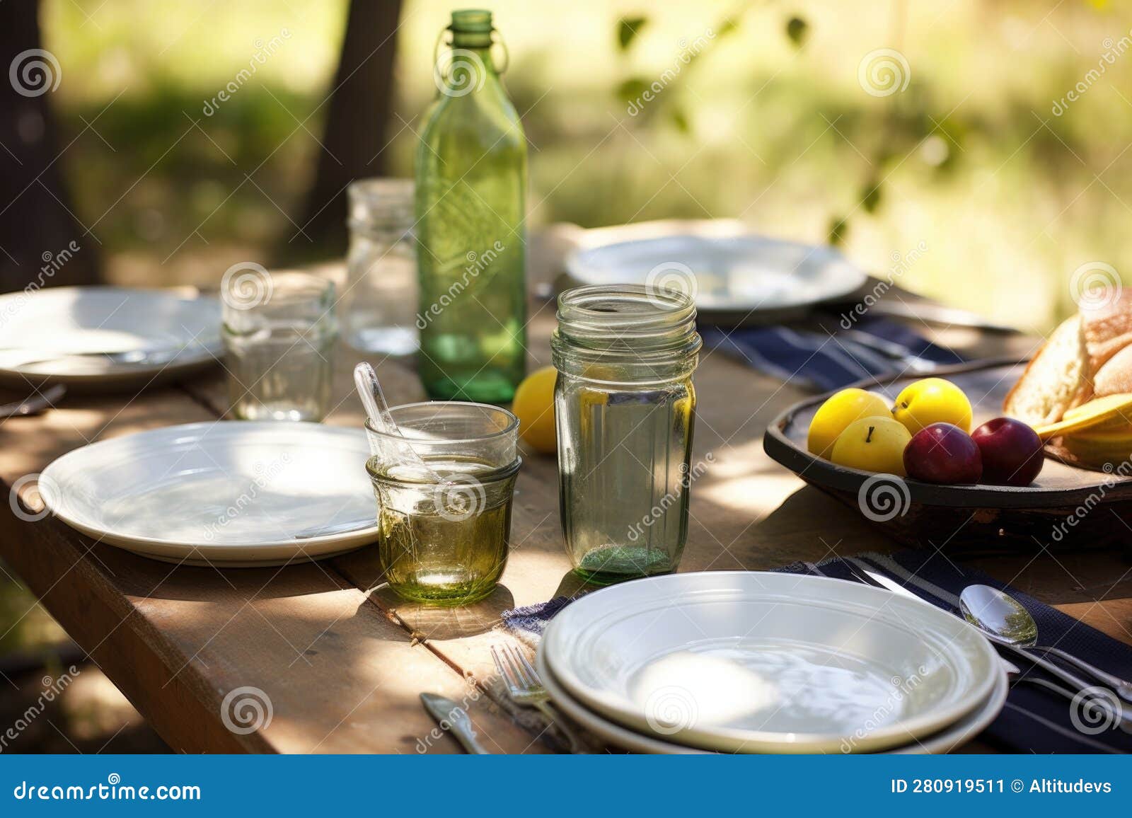A Simple Picnic Table Setting with Plates, Silverware and Glasses Stock ...