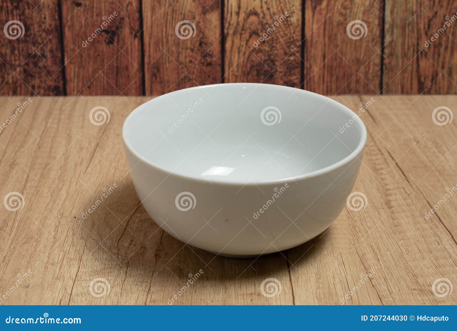 A Simple Picture of an Empty White Bowl on a Rustic Wooden Table Bathed ...