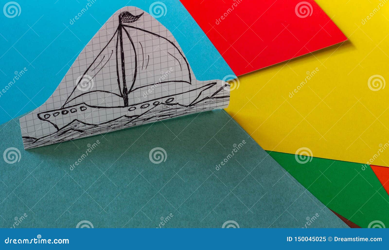 A Simple Ship Drawn on Paper Stands on a Multi-colored Cardboard Stock ...