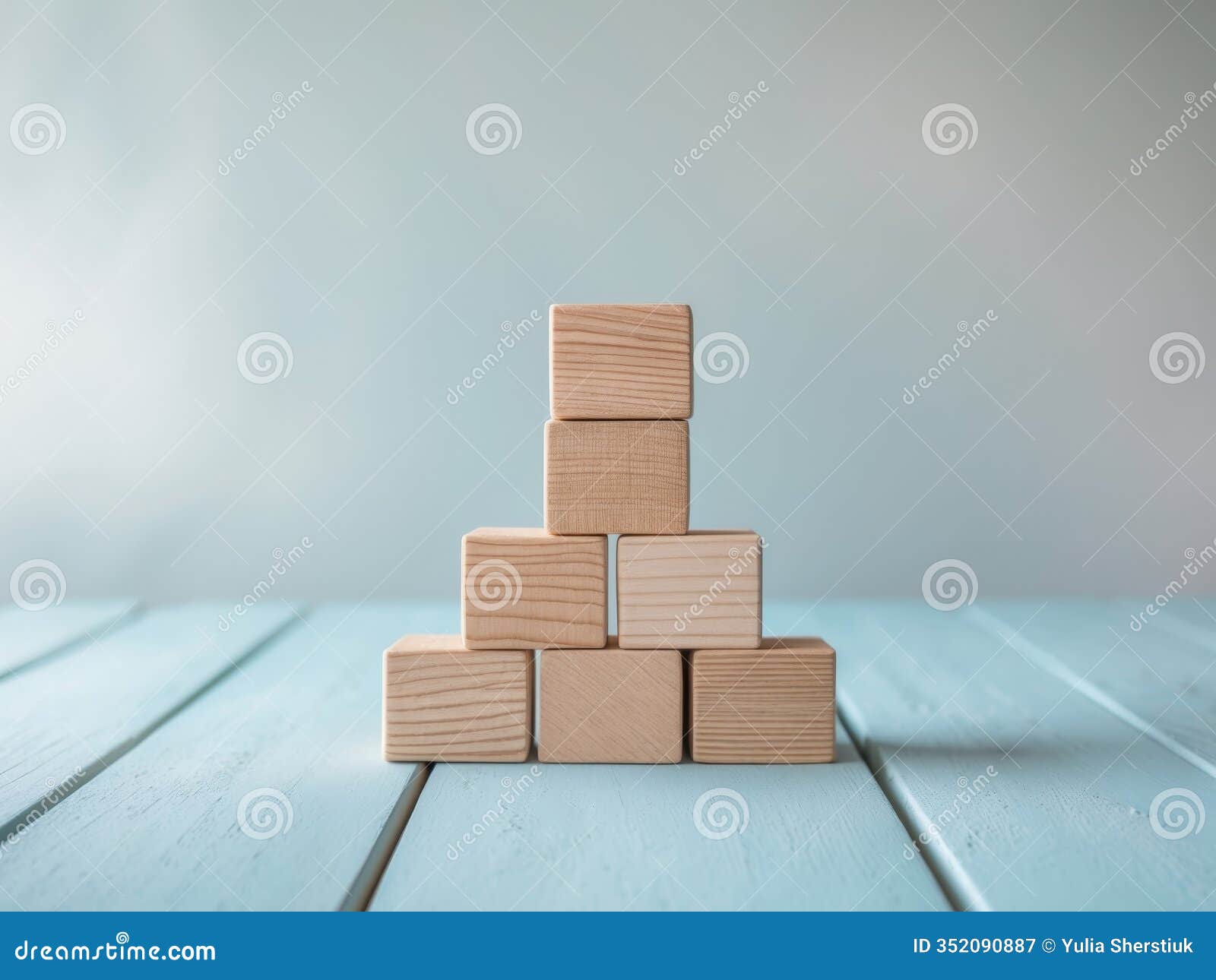 A Simple Stack of Wooden Blocks Arranged in a Pyramid Shape on a Light ...