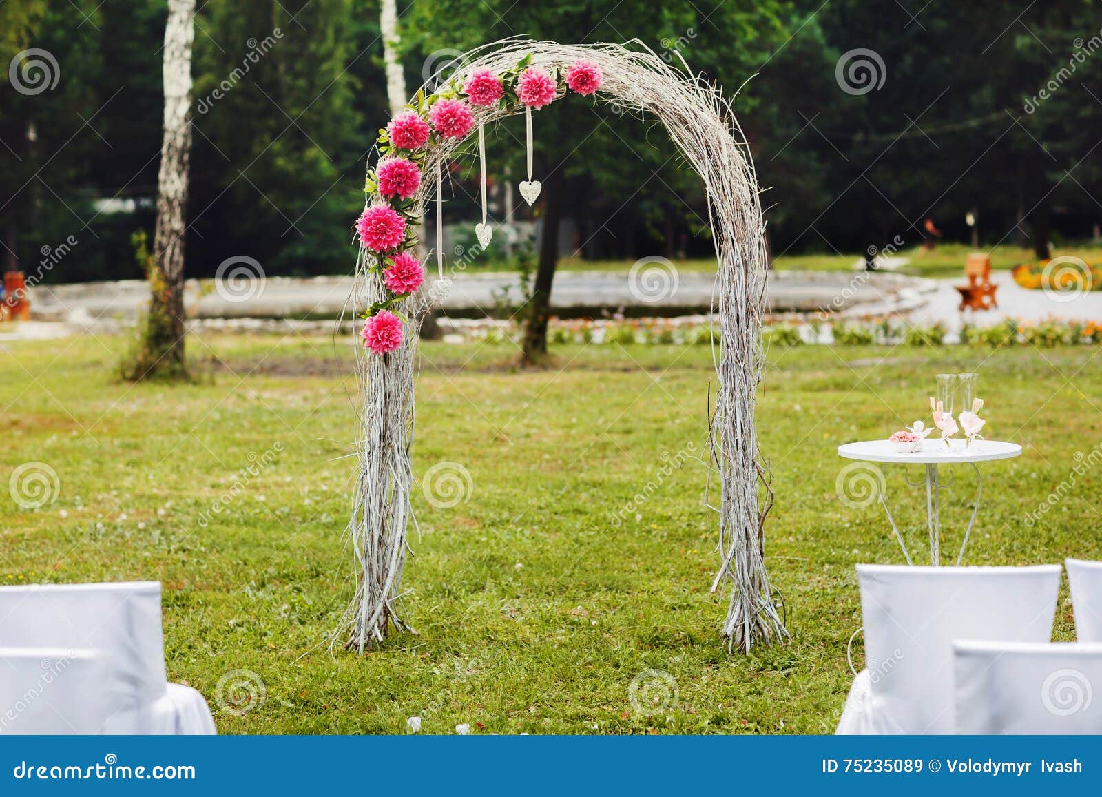 A Simple Wedding Altar with Pink Flowets Stands on the Field Stock ...