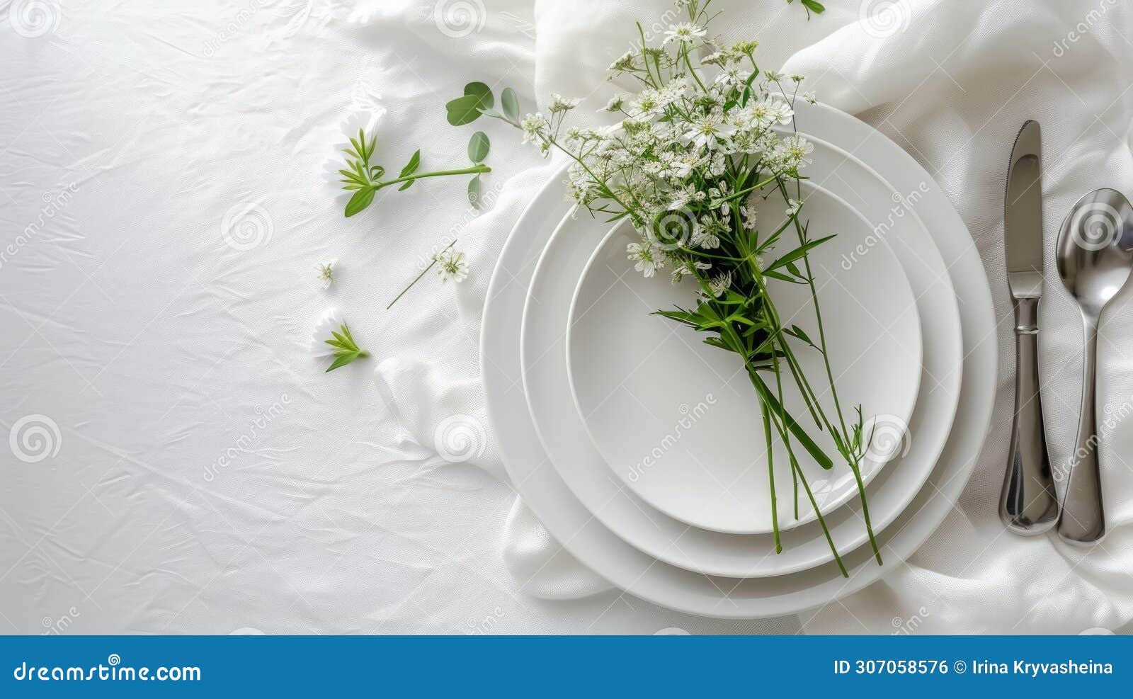 A Simple White Table Setting with a Small Bouquet of Wildflowers Stock ...